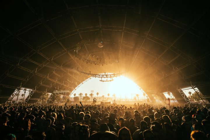 A view fo the sunset over the crowd at a House music festival - DJ Sonarm