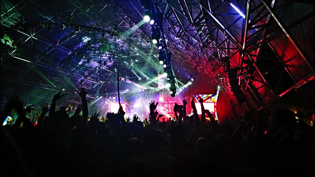 A view of the stage, roof and lights over the crowd at a Trance music ...